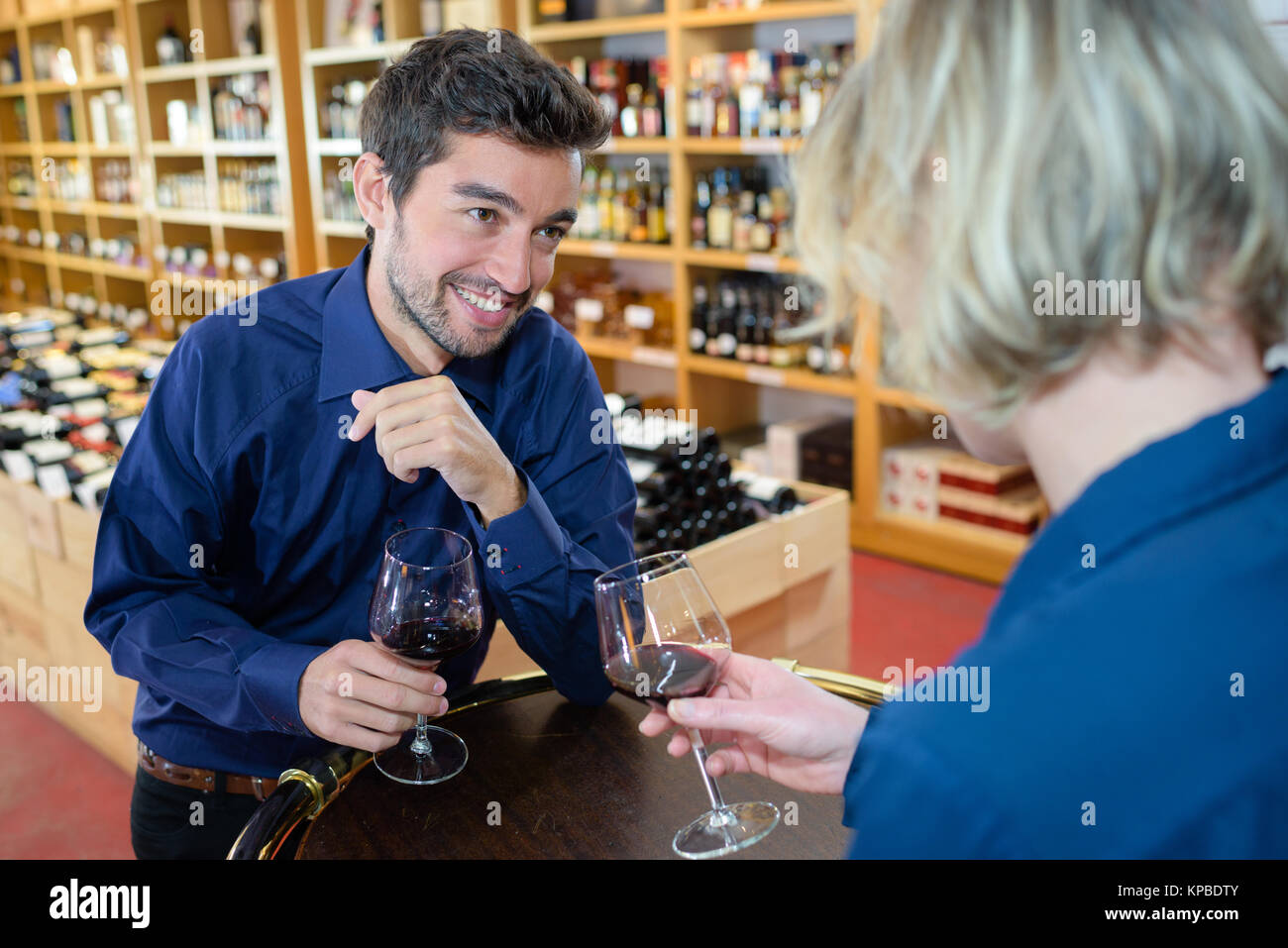 man and woman toasting with wine in a liquor store Stock Photo - Alamy