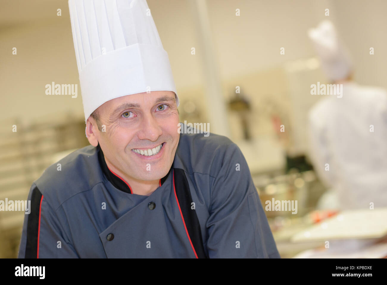 happy male chef posing in restaurant kitchen Stock Photo - Alamy