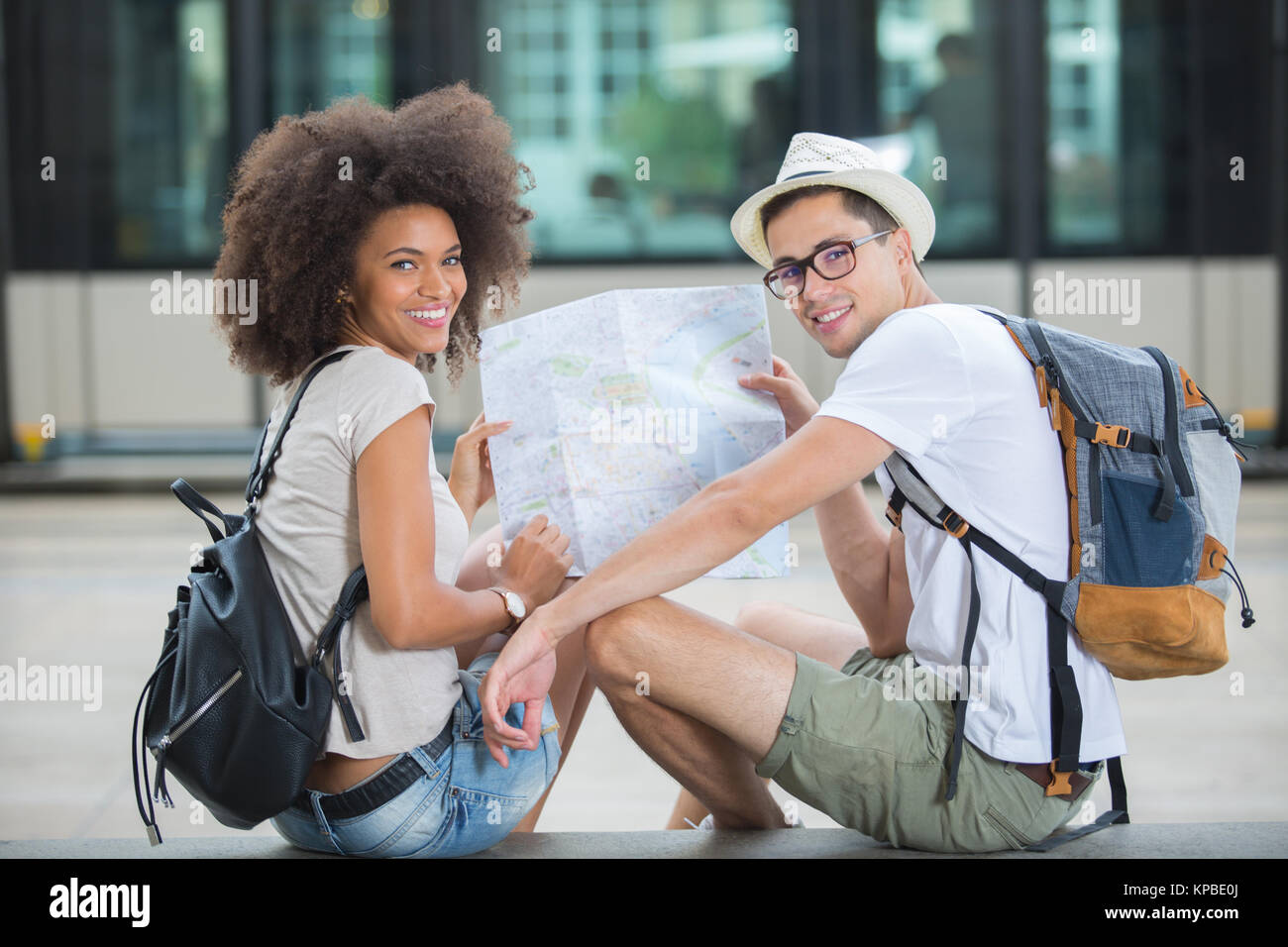 young happy couple traveling with maps in hand Stock Photo - Alamy
