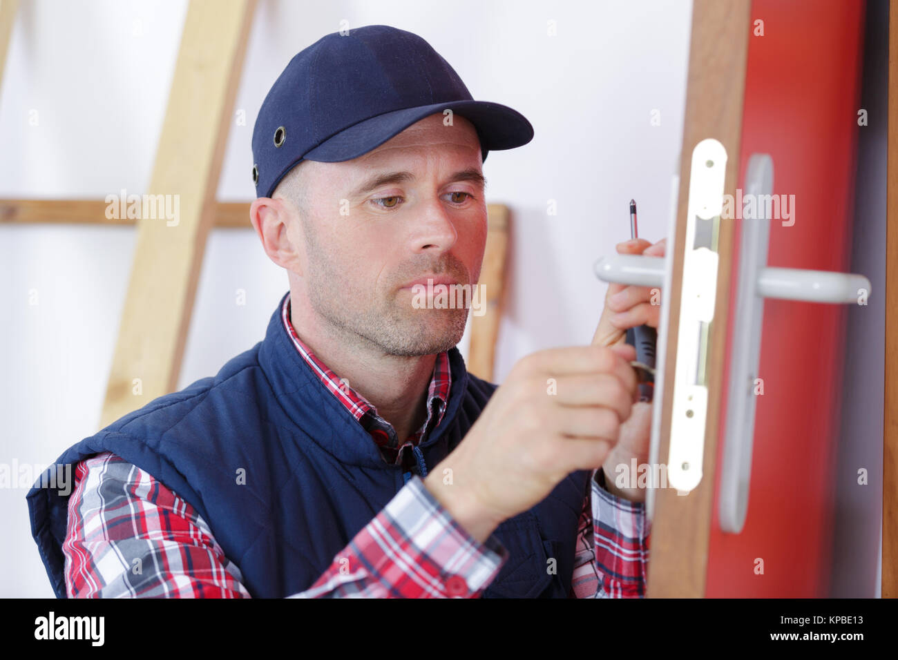 man fixing the door with screwdriver Stock Photo - Alamy