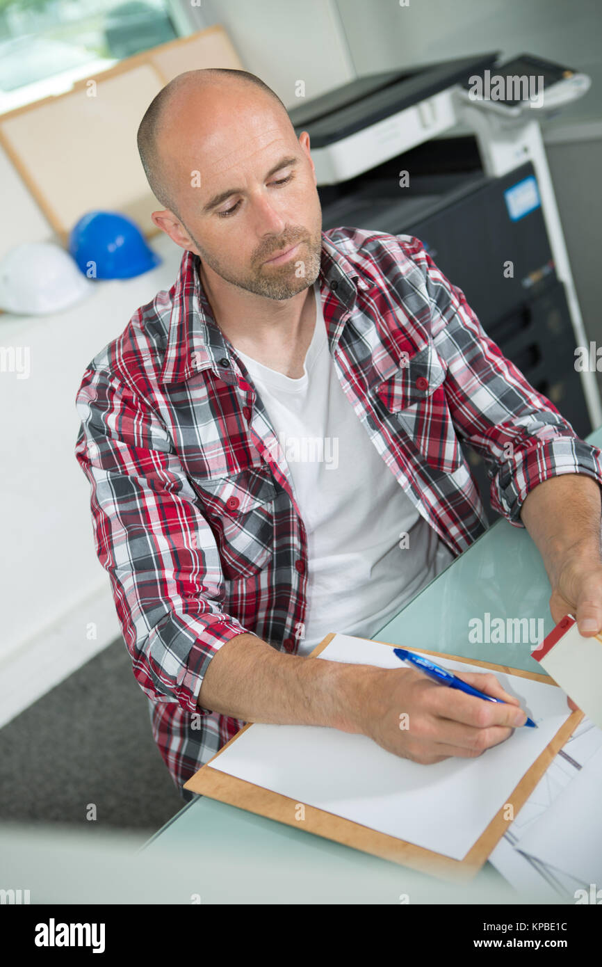 architecture man writing paper at a table office Stock Photo - Alamy