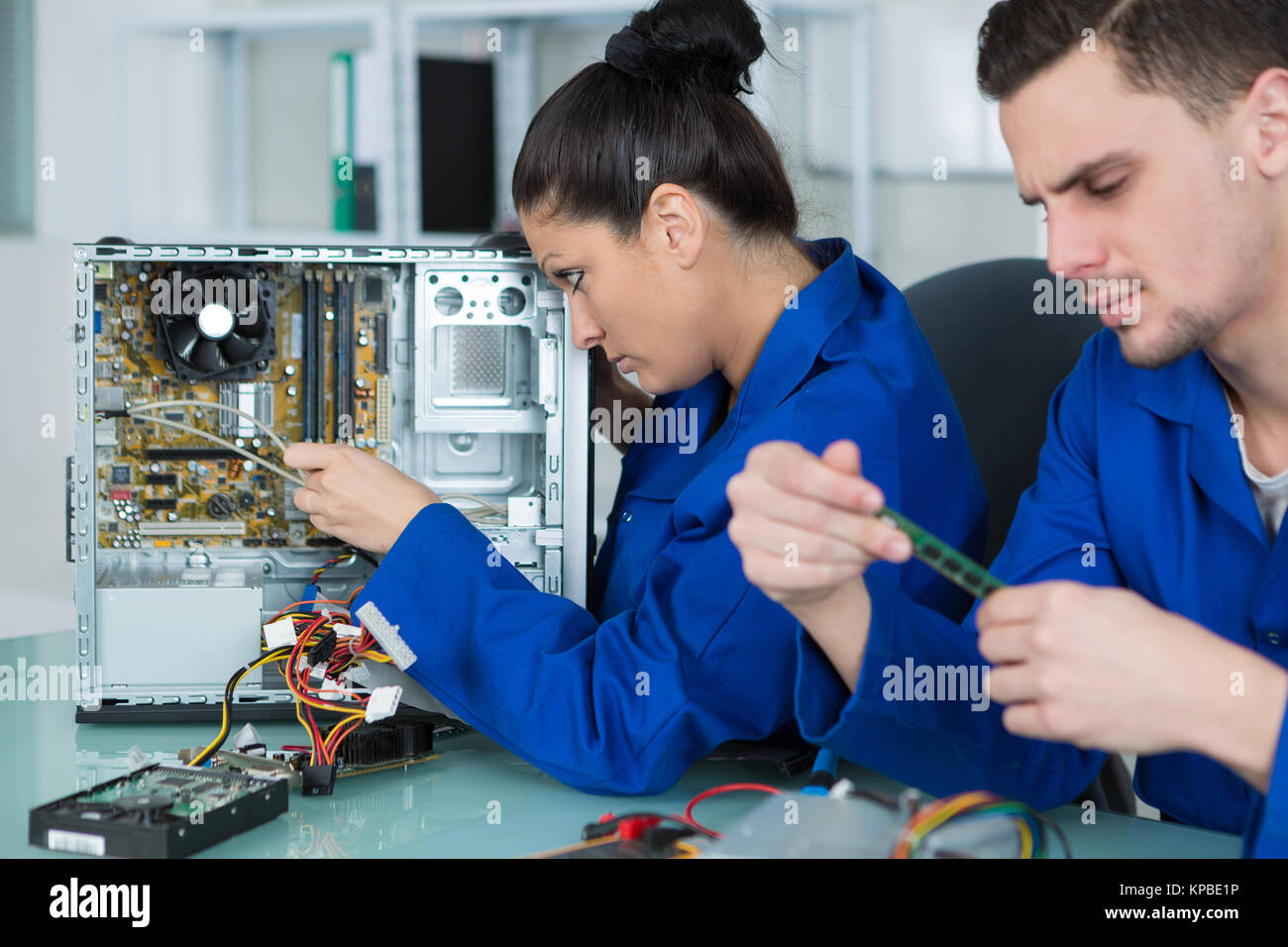 fixing computer in the office Stock Photo - Alamy