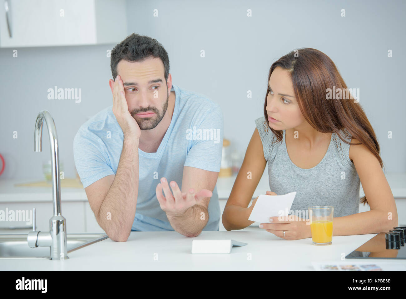 Couple arguing in the kitchen Stock Photo - Alamy