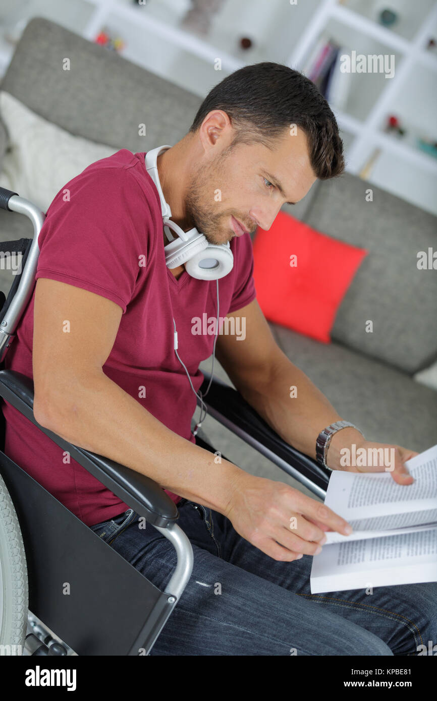 disabled businessman in wheelchair reading a book Stock Photo - Alamy