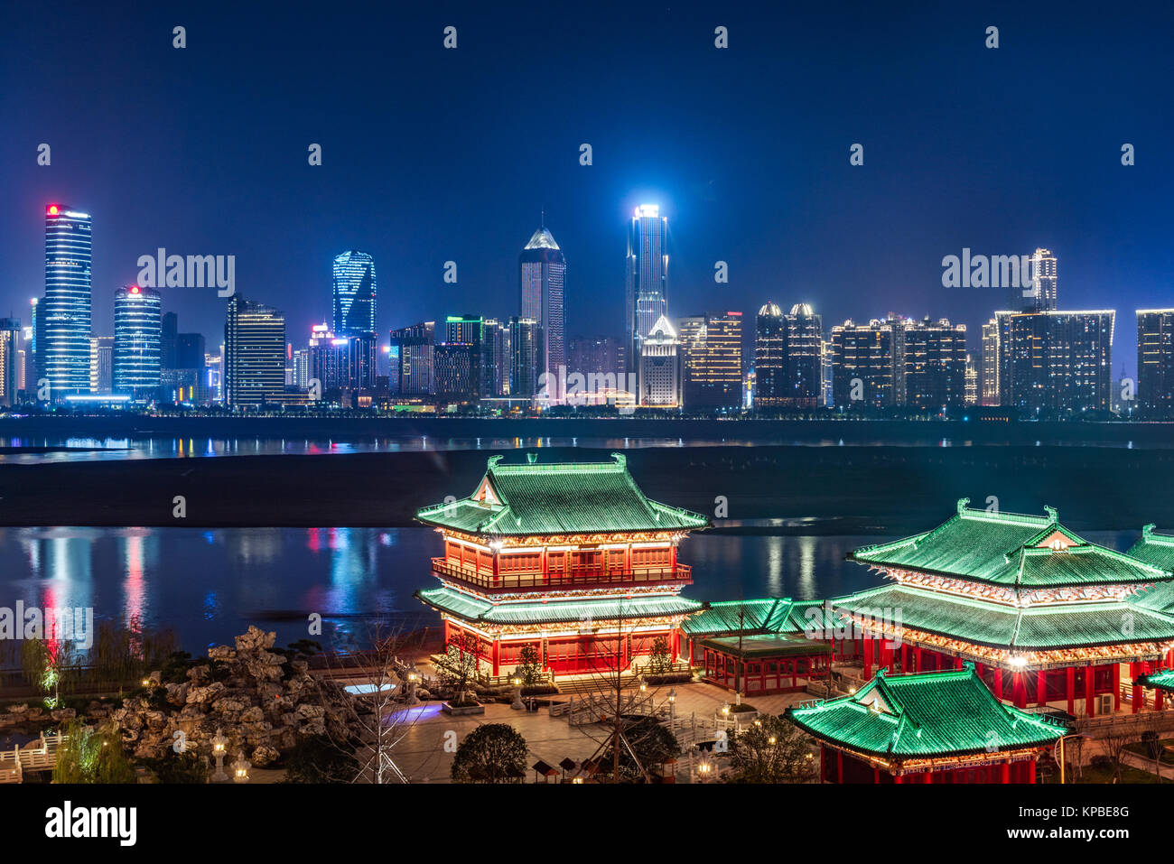 buildings standing by riverside under dramatic sky in Nanchang,China ...
