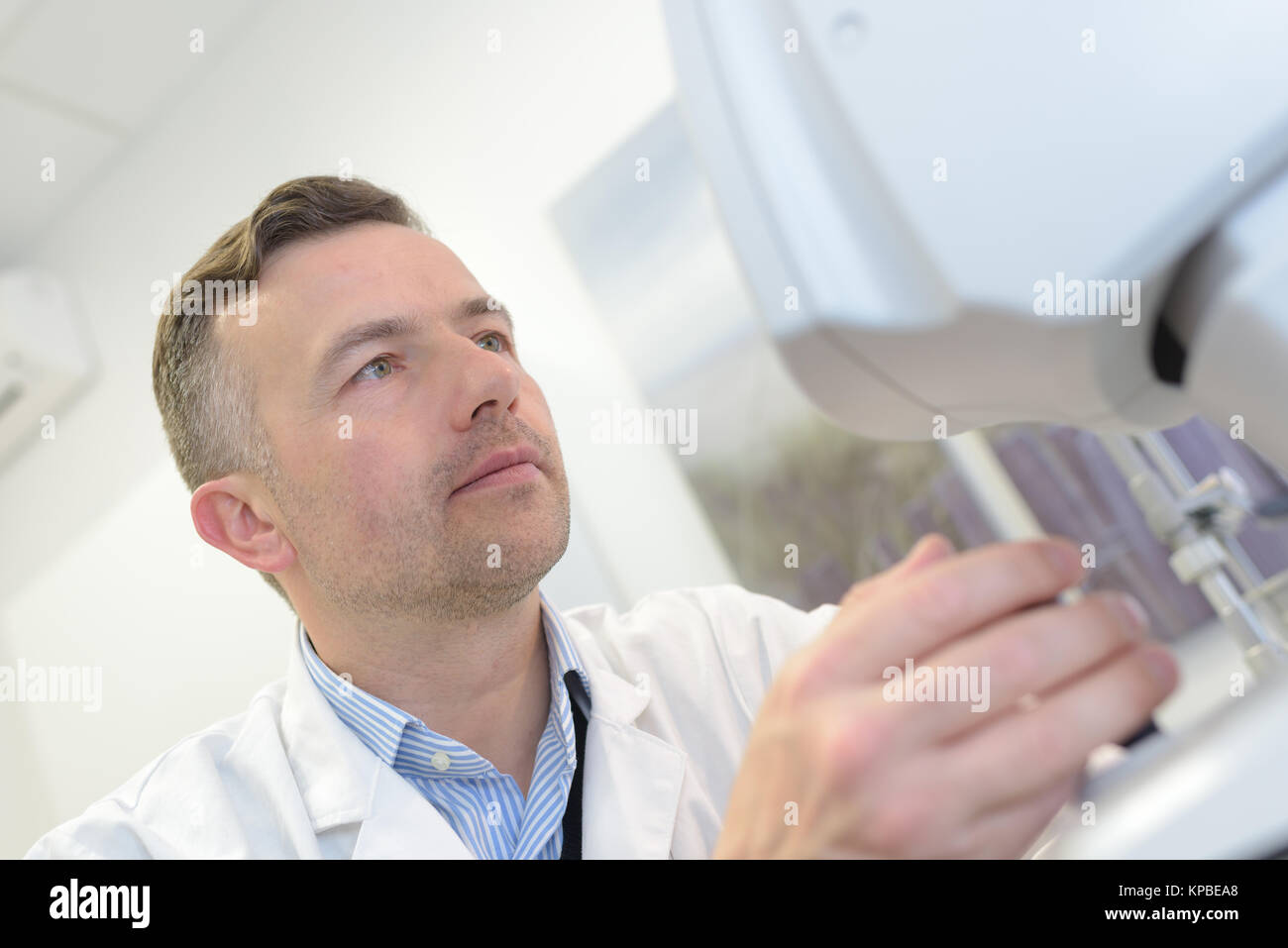 doctor supervising examination of a sportsman on the computer screen ...