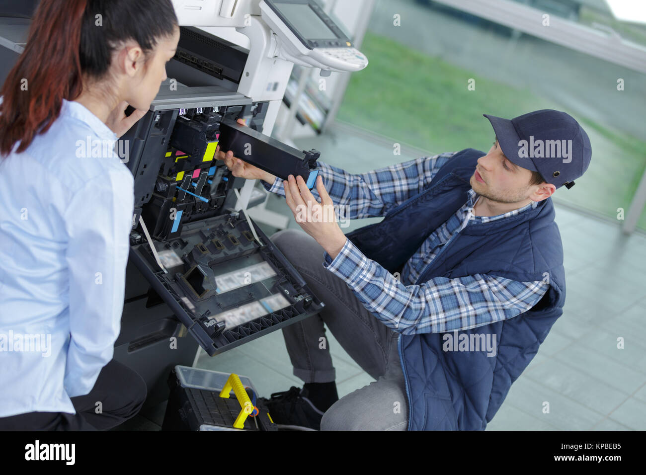 male technician fixing a printer Stock Photo - Alamy