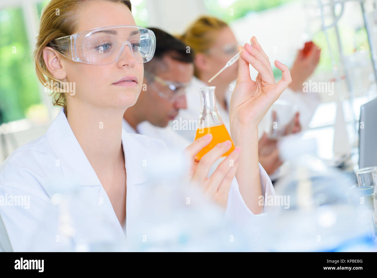 Female laboratory technician using pipette Stock Photo - Alamy