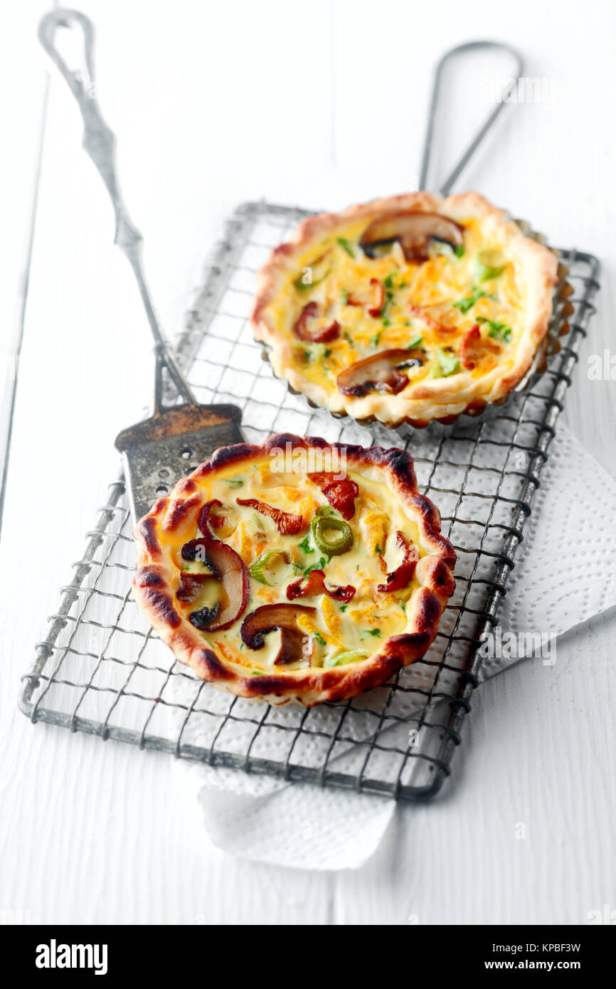 Homemade savory autumn quiche with fresh seasonal mushrooms in a crisp ...