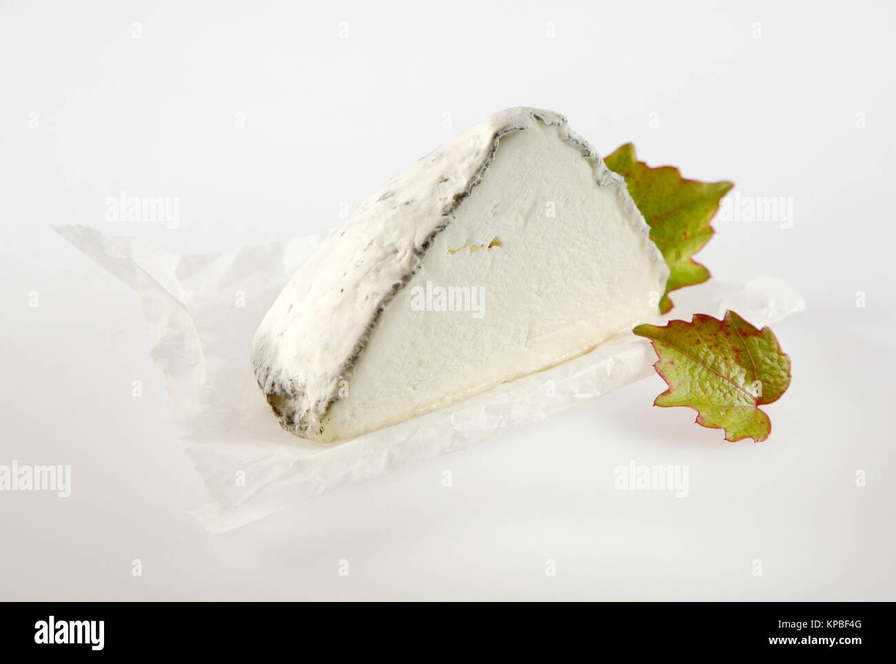Food Still Life - Wedge of Aged Cheese with Two Green Leaves as Garnish ...