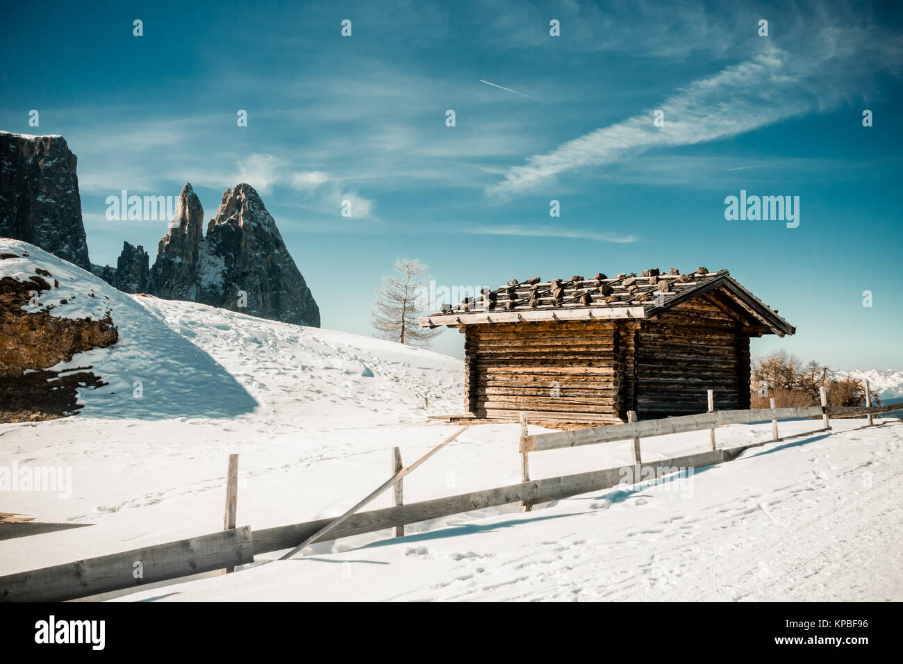 Winter scenic mountainous landscape with rustic brown wooden hut or ...