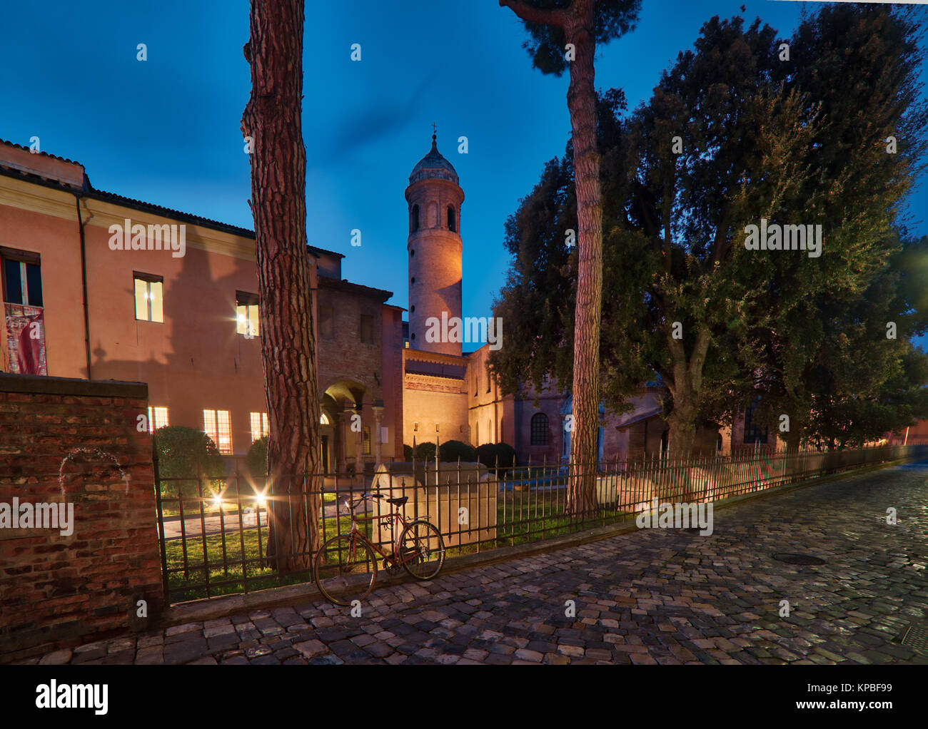 night view of cobbled street along monumental complex in Ravenna, once ...