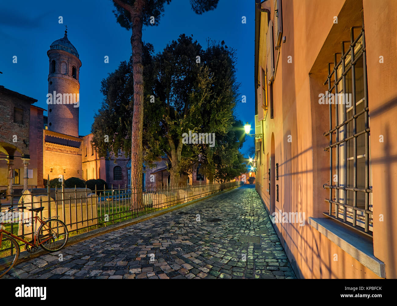 night view of cobbled street along monumental complex in Ravenna, once ...