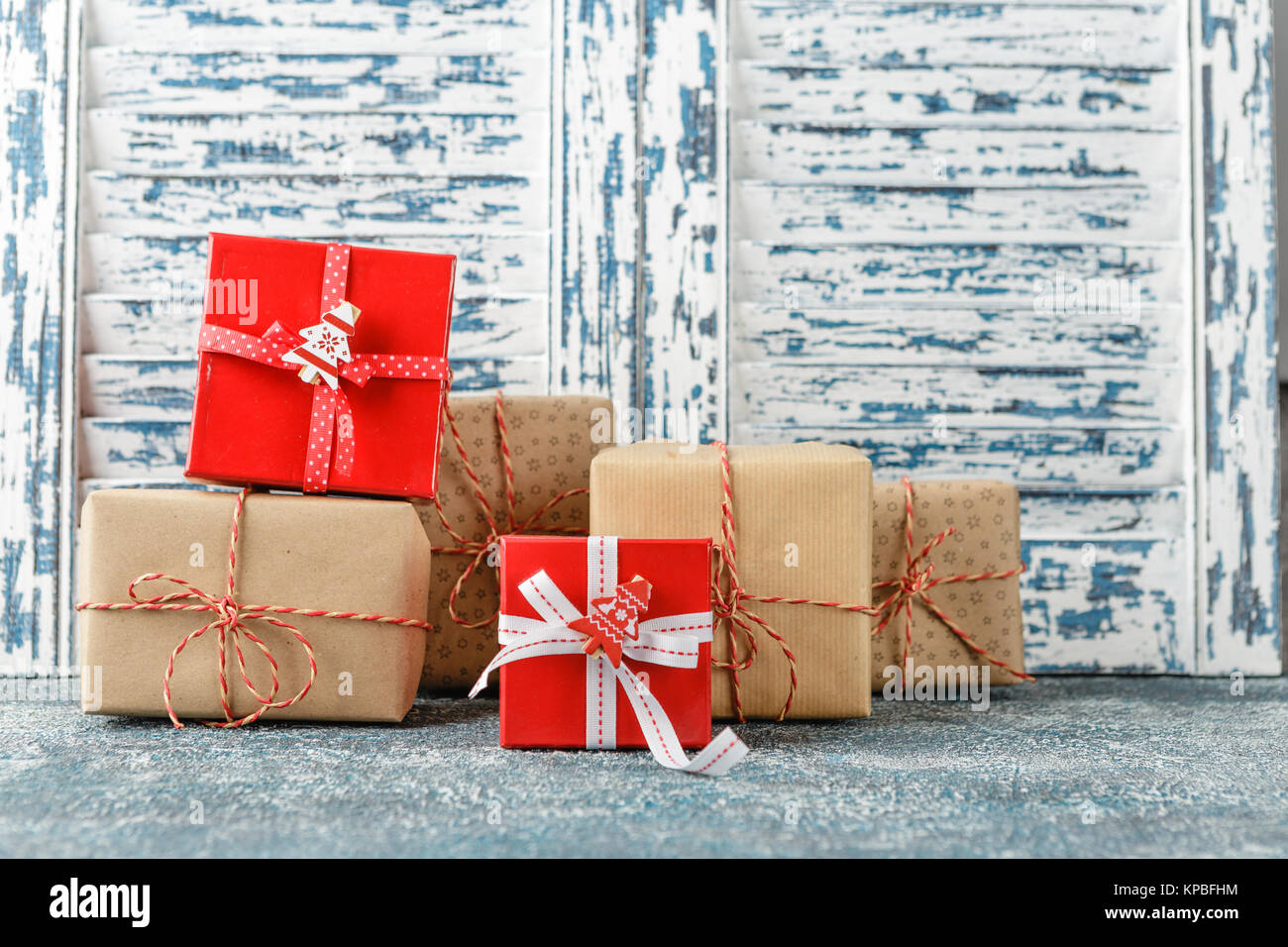 Christmas red and craft paper gift boxes on blue background Stock Photo ...