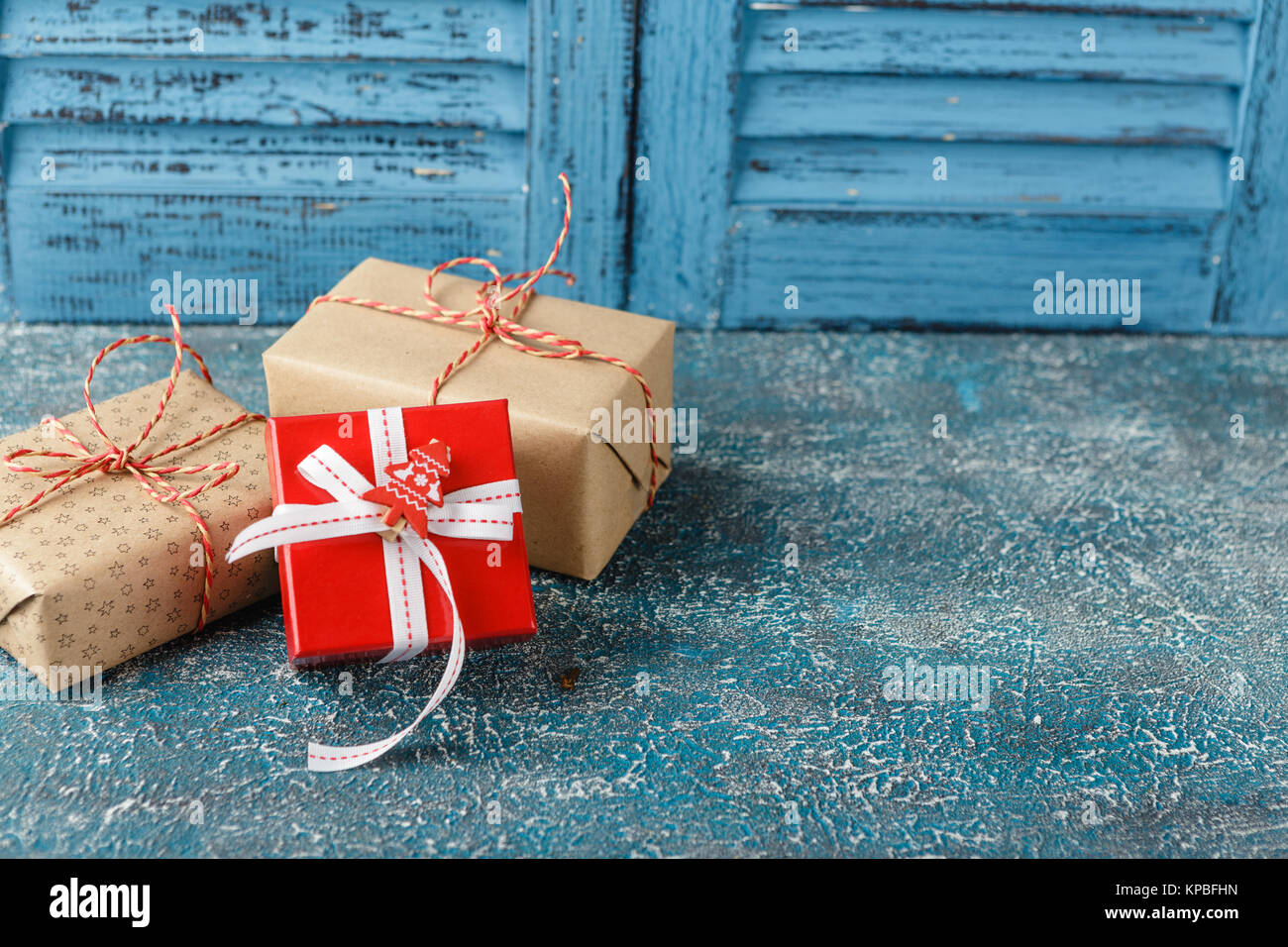 Christmas red and craft paper gift boxes on blue background Stock Photo ...