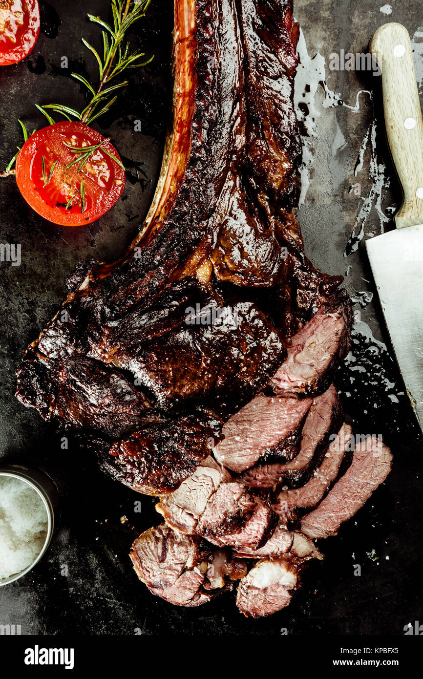 Delicious grilled lean tomahawk beef steak cut through to reveal the ...