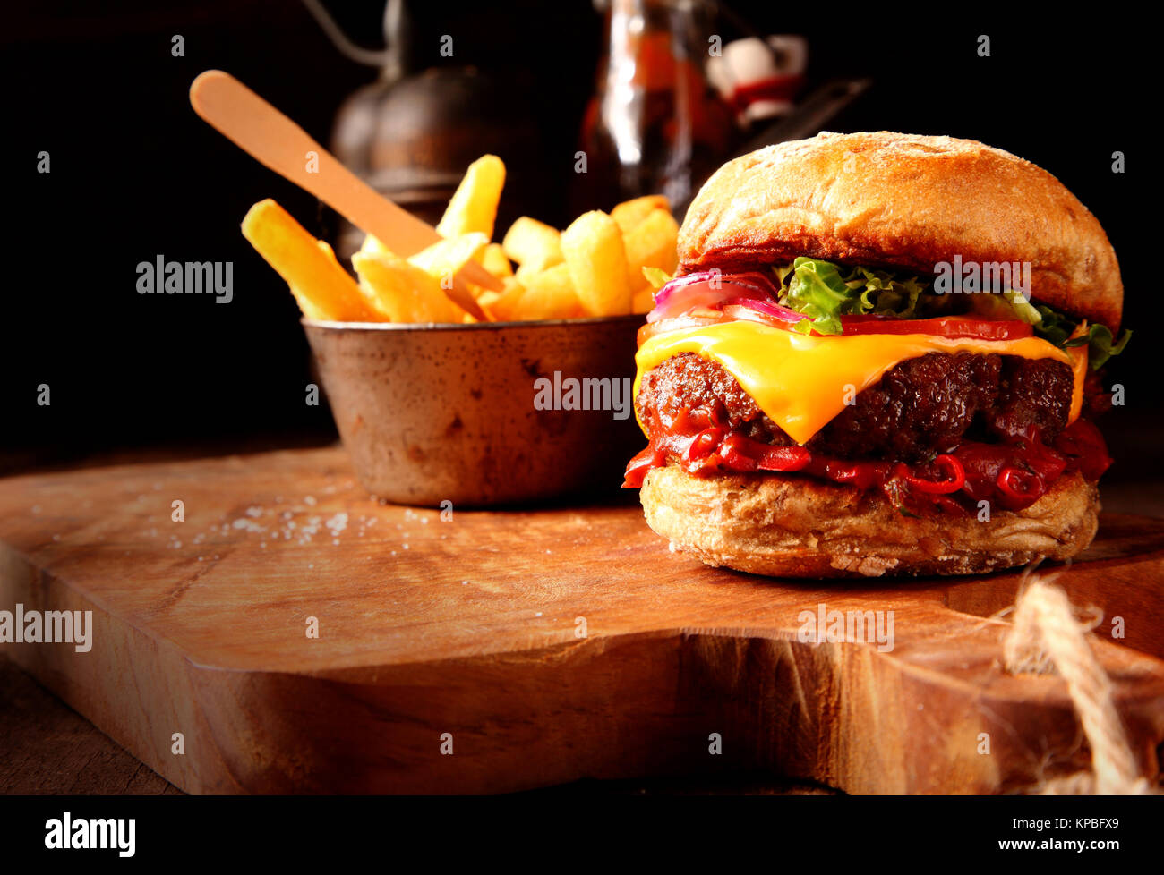 Modern Fast Food homemade burger with chips or french fries for ...