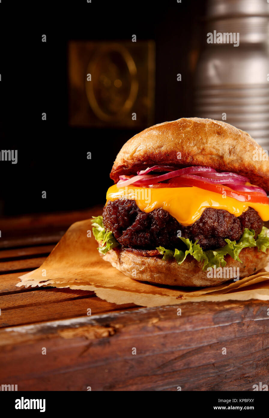 Delicious fast food cheeseburger with melted cheese on a beef patty ...