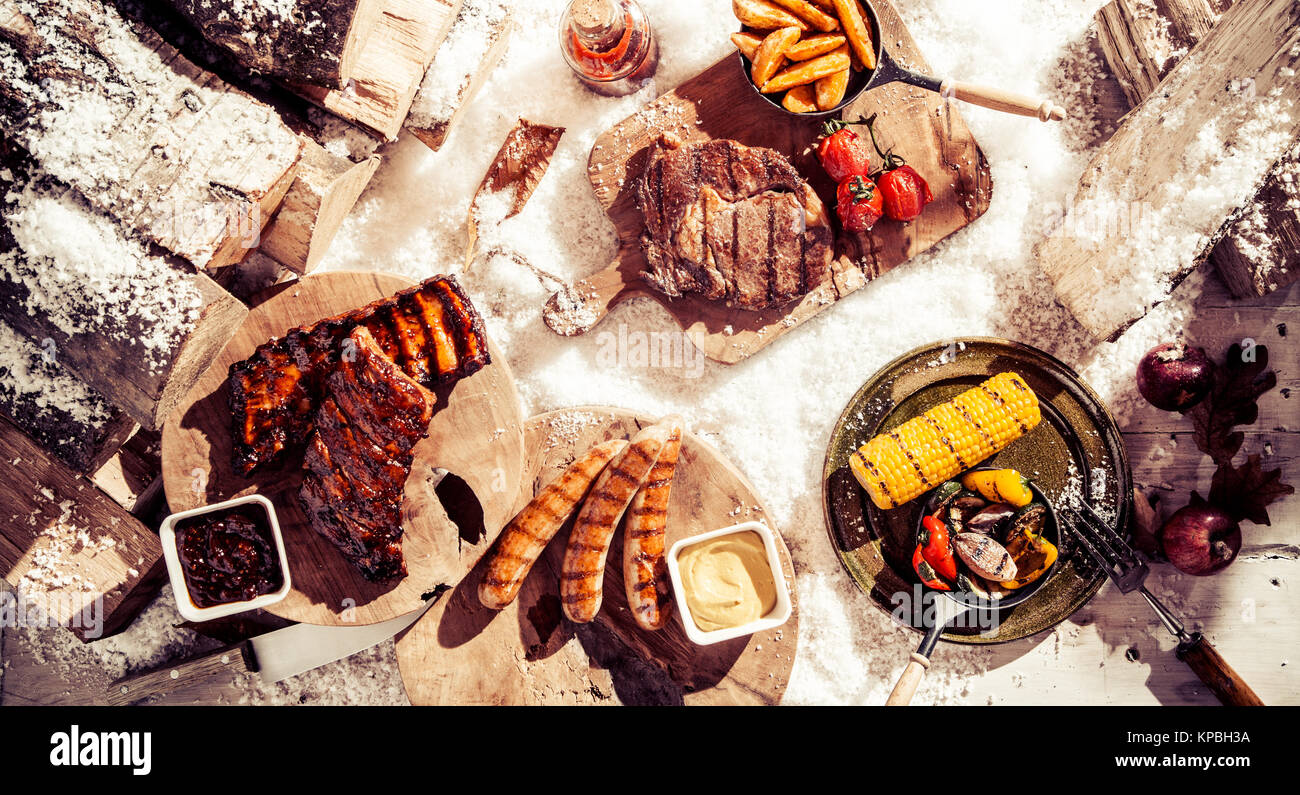 Delicious winter barbecue spread with assorted grilled marinated meat ...