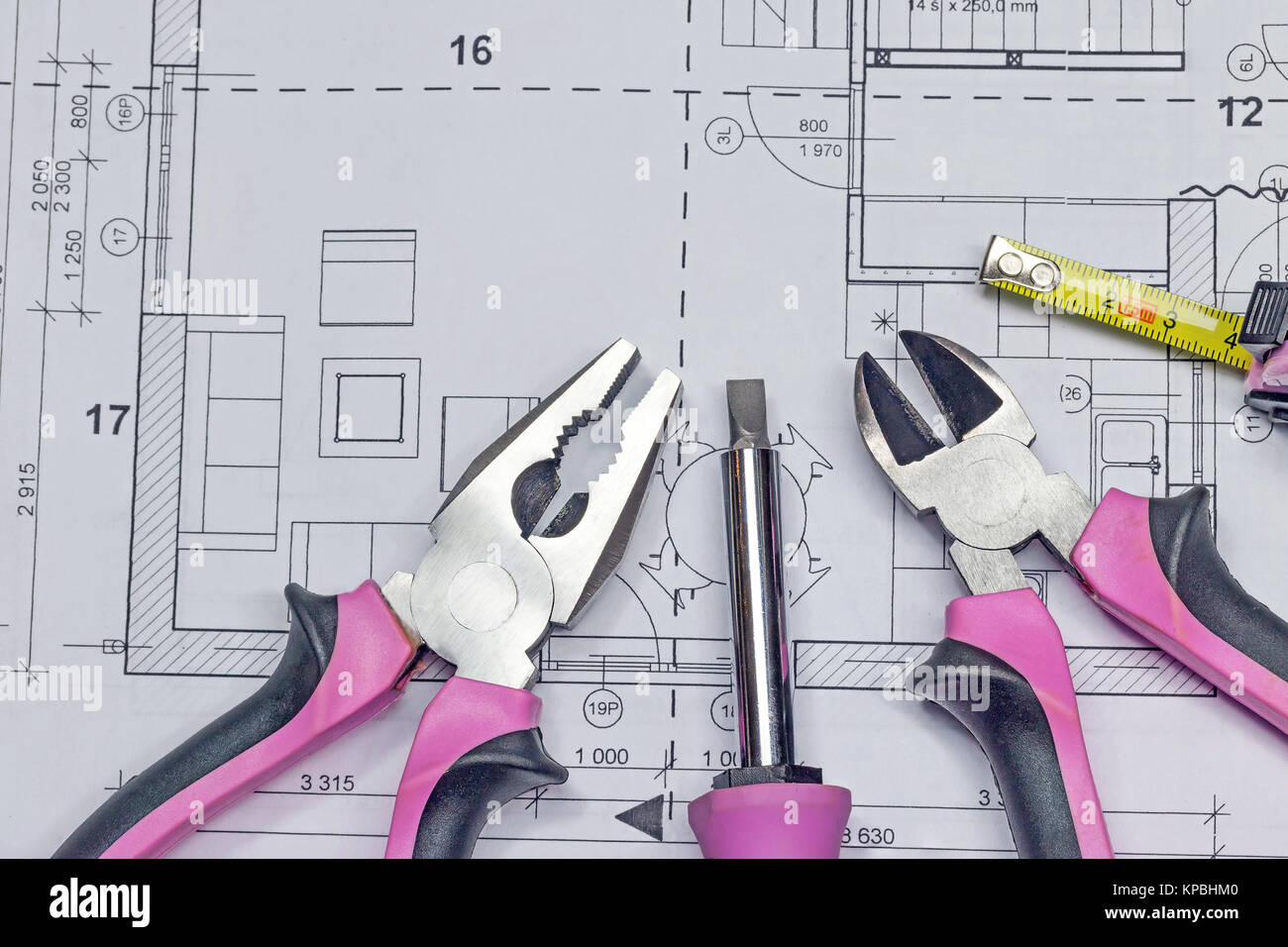 Tolls with pink degign on the blueprint Stock Photo - Alamy