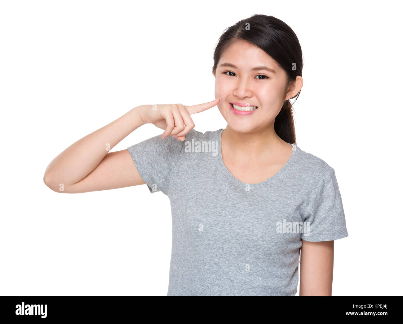 Young woman finger point to her teeth Stock Photo - Alamy