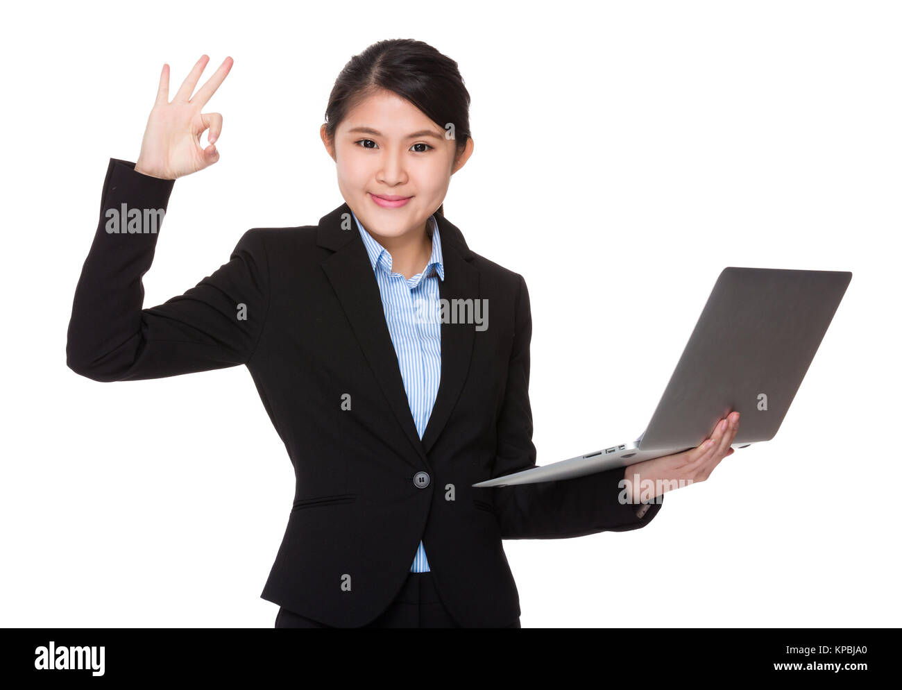 Businesswoman hold laptop computer and with ok sign gesture Stock Photo - Alamy