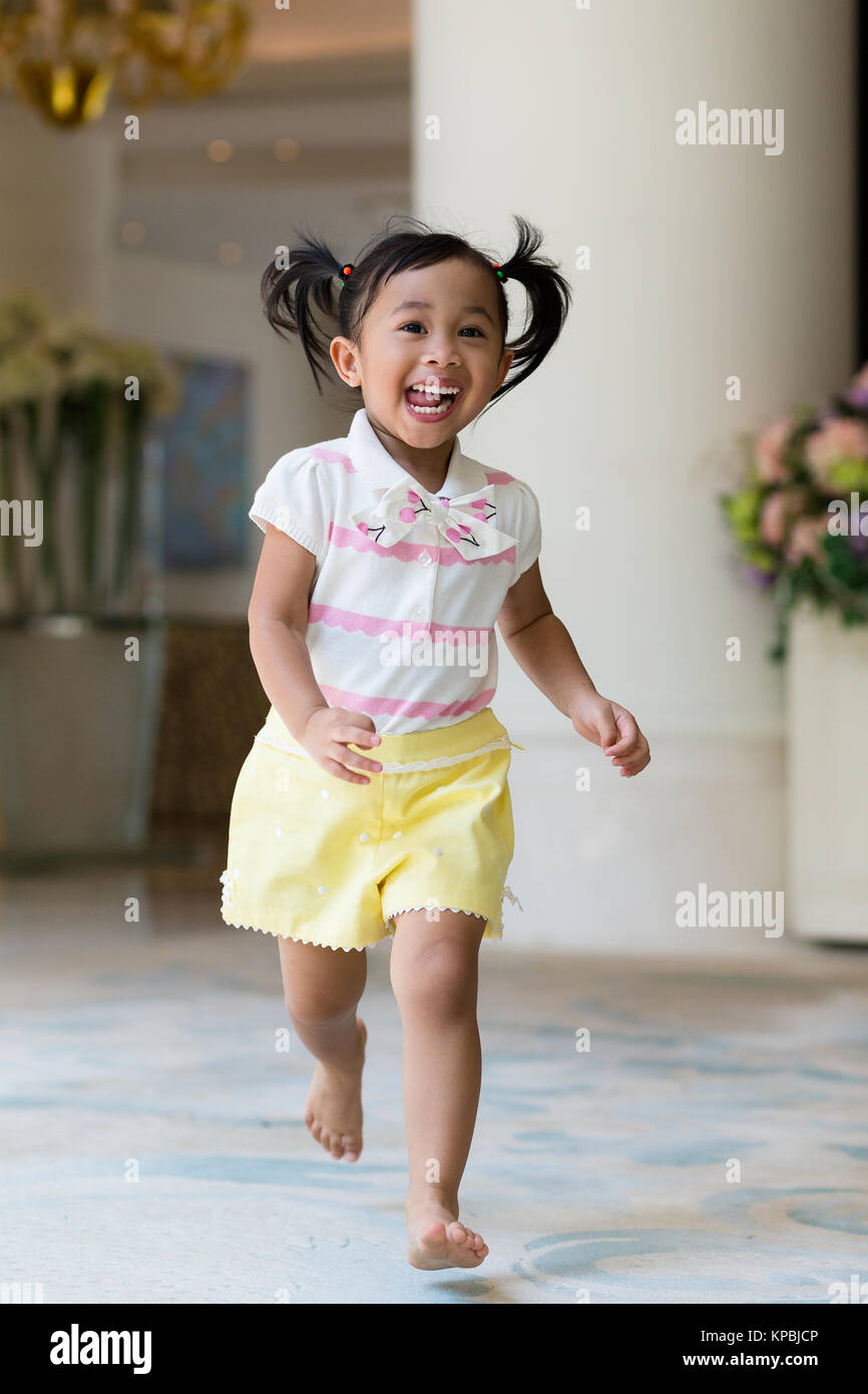 Happy girl running at home Stock Photo - Alamy