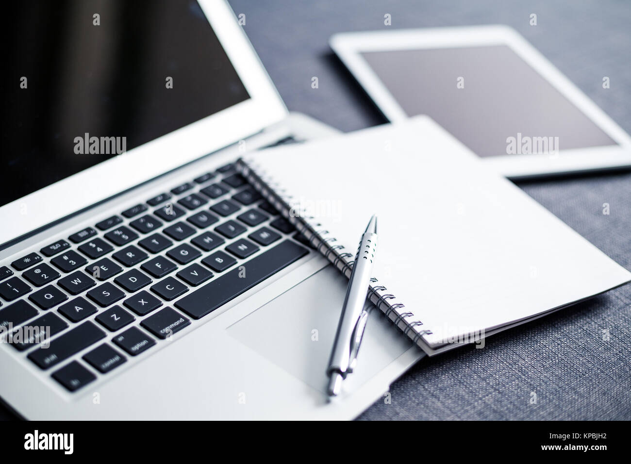 Laptop, tablet and note book Stock Photo - Alamy