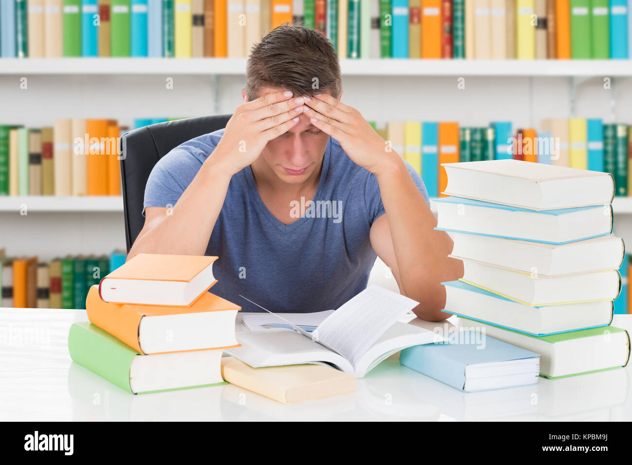 Tensed University Student Sitting In Library Stock Photo - Alamy