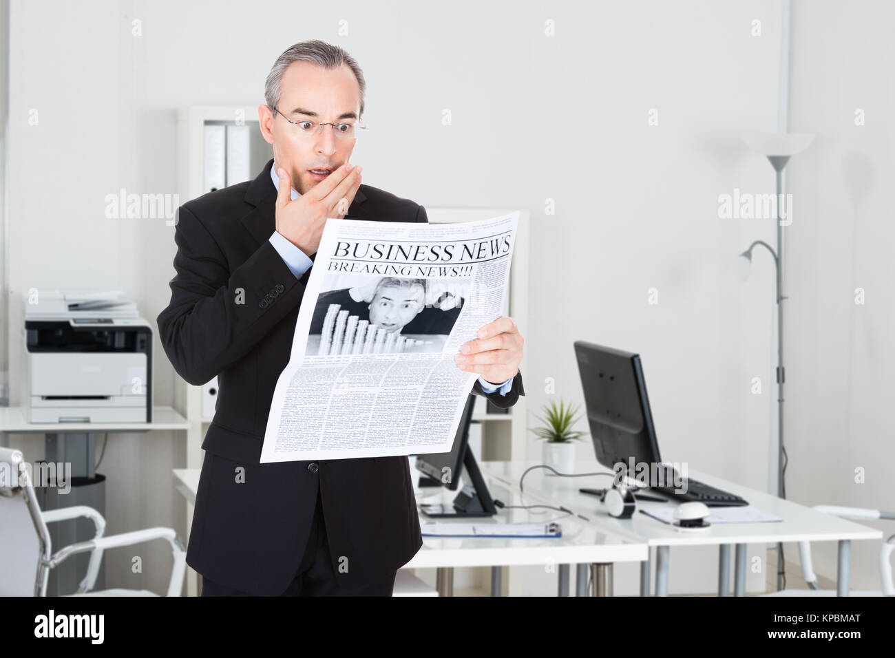 Businessman With Newspaper Stock Photo - Alamy