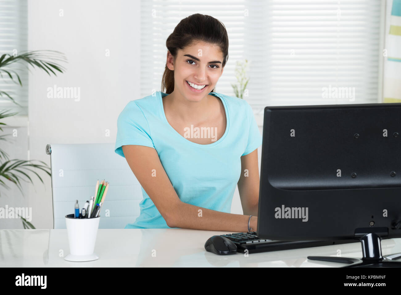 Happy Student Using Computer At Table Stock Photo - Alamy