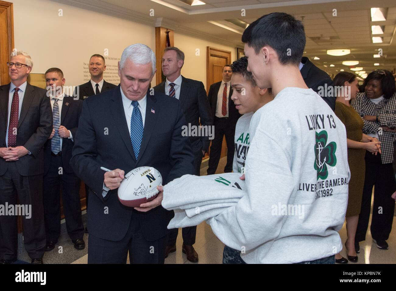 U.S. Vice President Mike Pence signs a football during the U.S. Naval ...