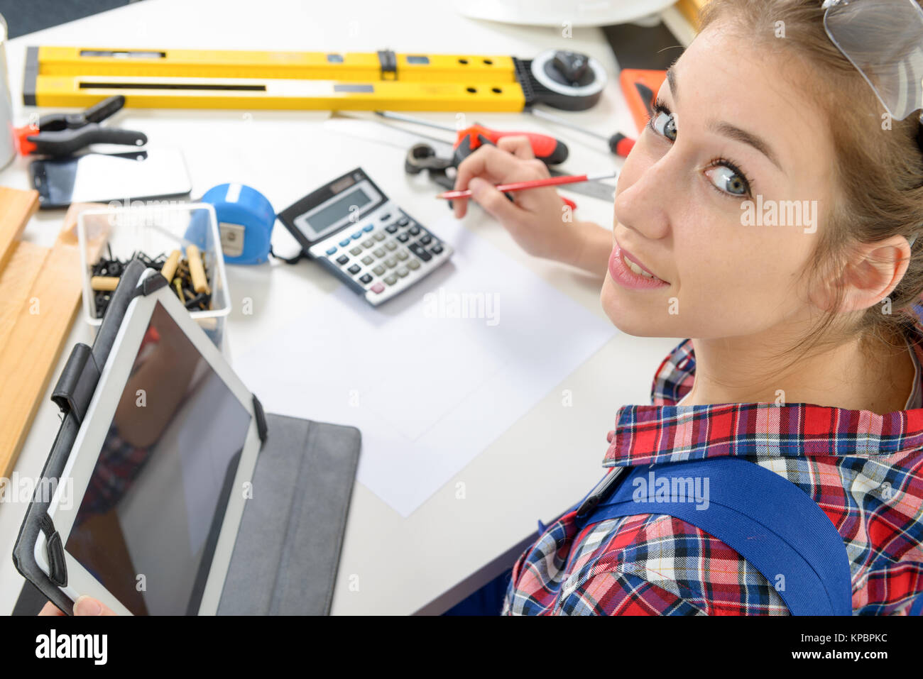 young woman carpenter sitting at desk in her workshop Stock Photo - Alamy