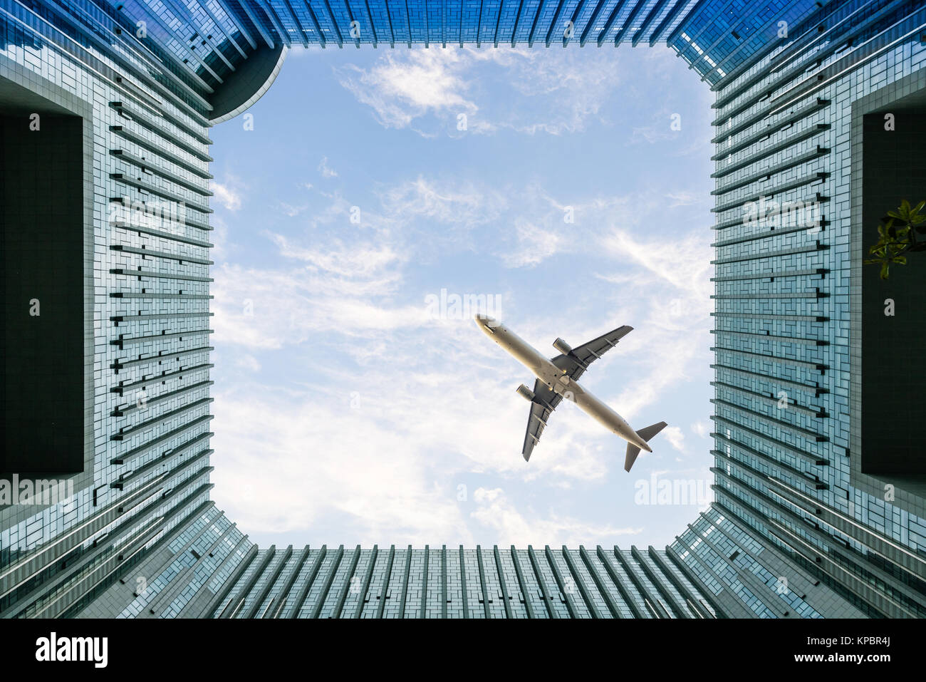 Directly below shot of airplane in middle of buildings Stock Photo - Alamy