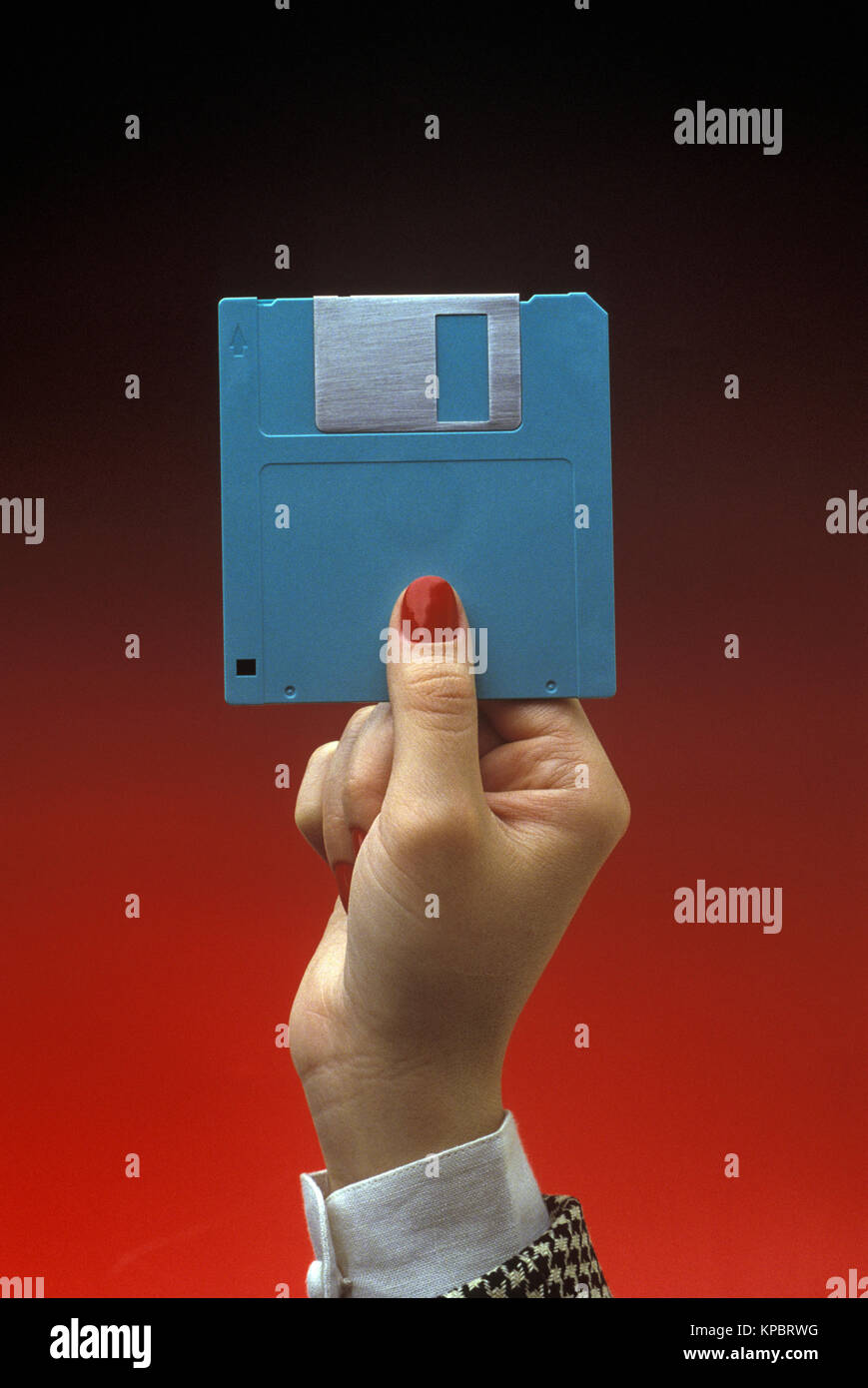1991 HISTORICAL WOMAN’S HAND HOLDING BLUE 3.5 INCH MICRO FLOPPY DISC ...