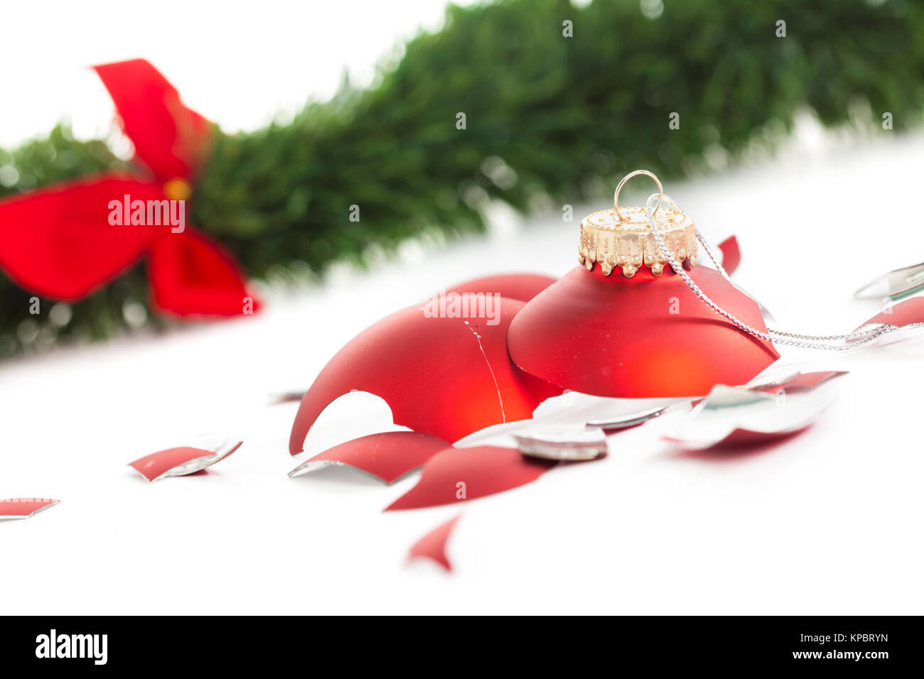 Broken red christmas tree bauble with garland in background Stock Photo ...