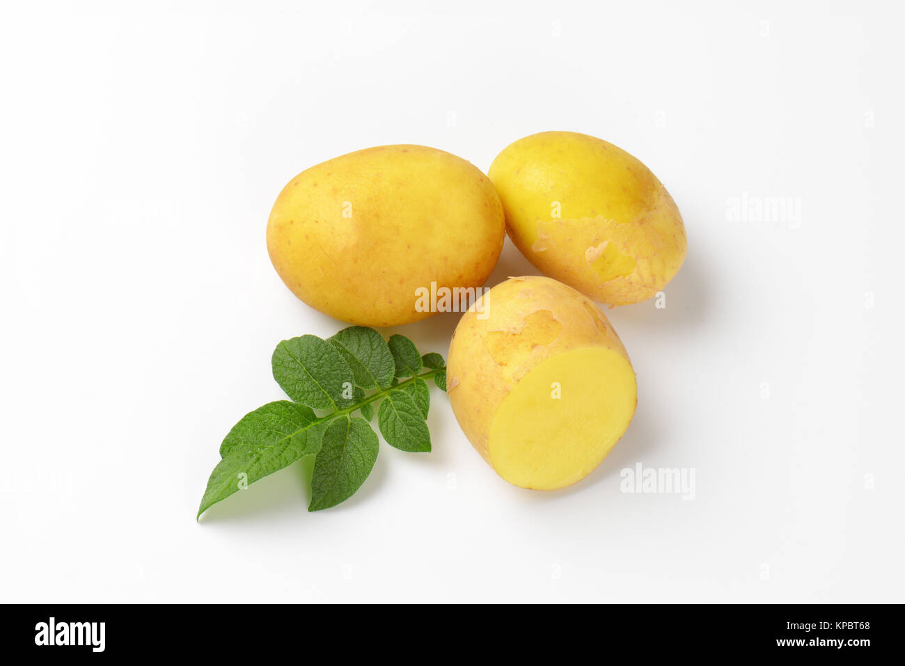 two whole potatoes and one half Stock Photo - Alamy
