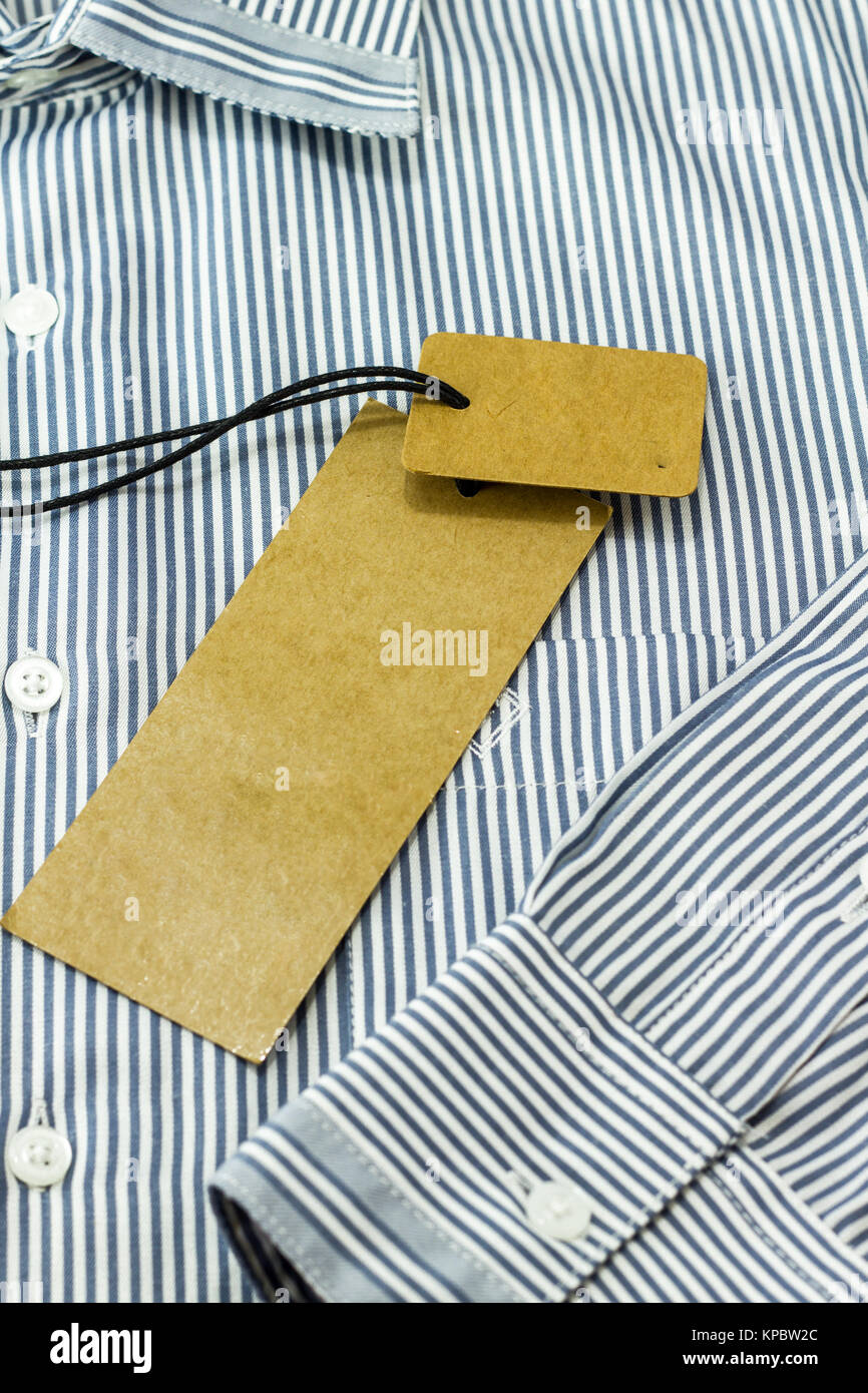 Tag label on blue shirt Stock Photo - Alamy