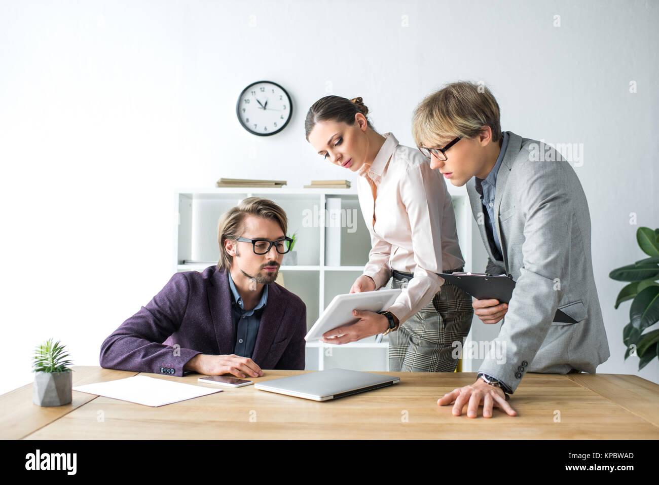 Woman showing something on laptop Stock Photo - Alamy