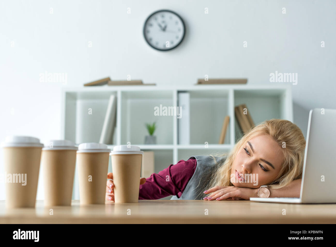 Tired businesswoman lying on table Stock Photo - Alamy