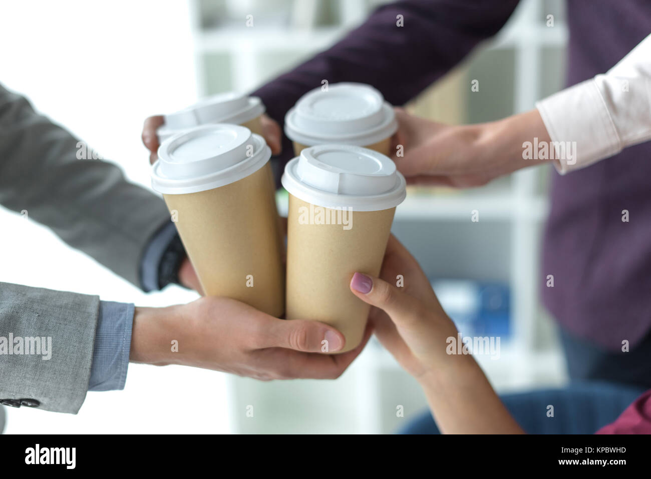 business partners clinking coffee cups Stock Photo - Alamy