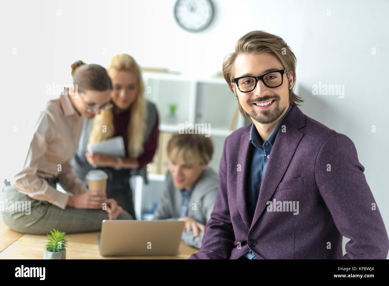 Smiling team leader Stock Photo - Alamy