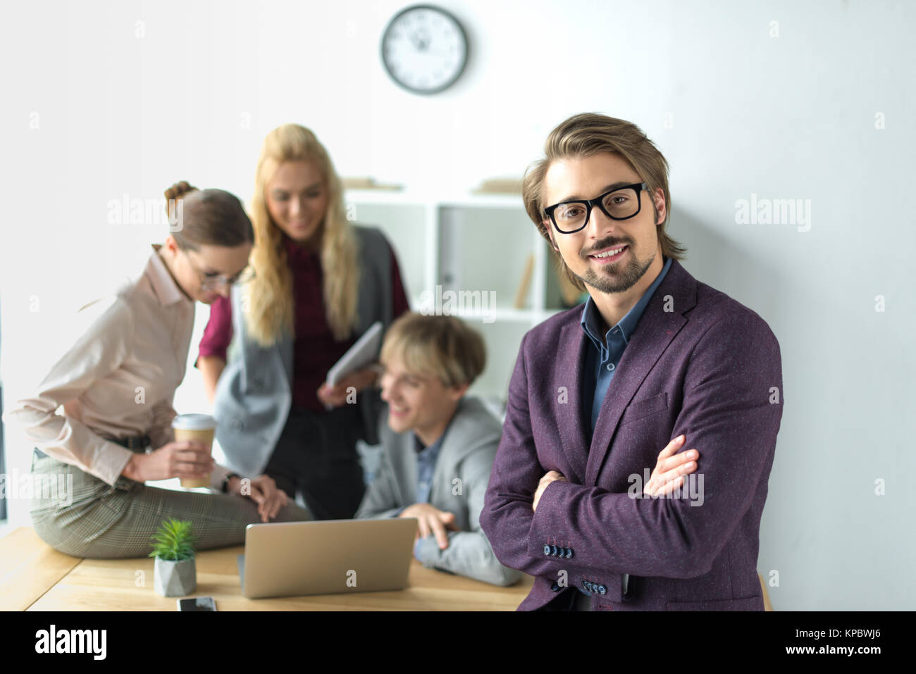 Smiling team leader Stock Photo - Alamy
