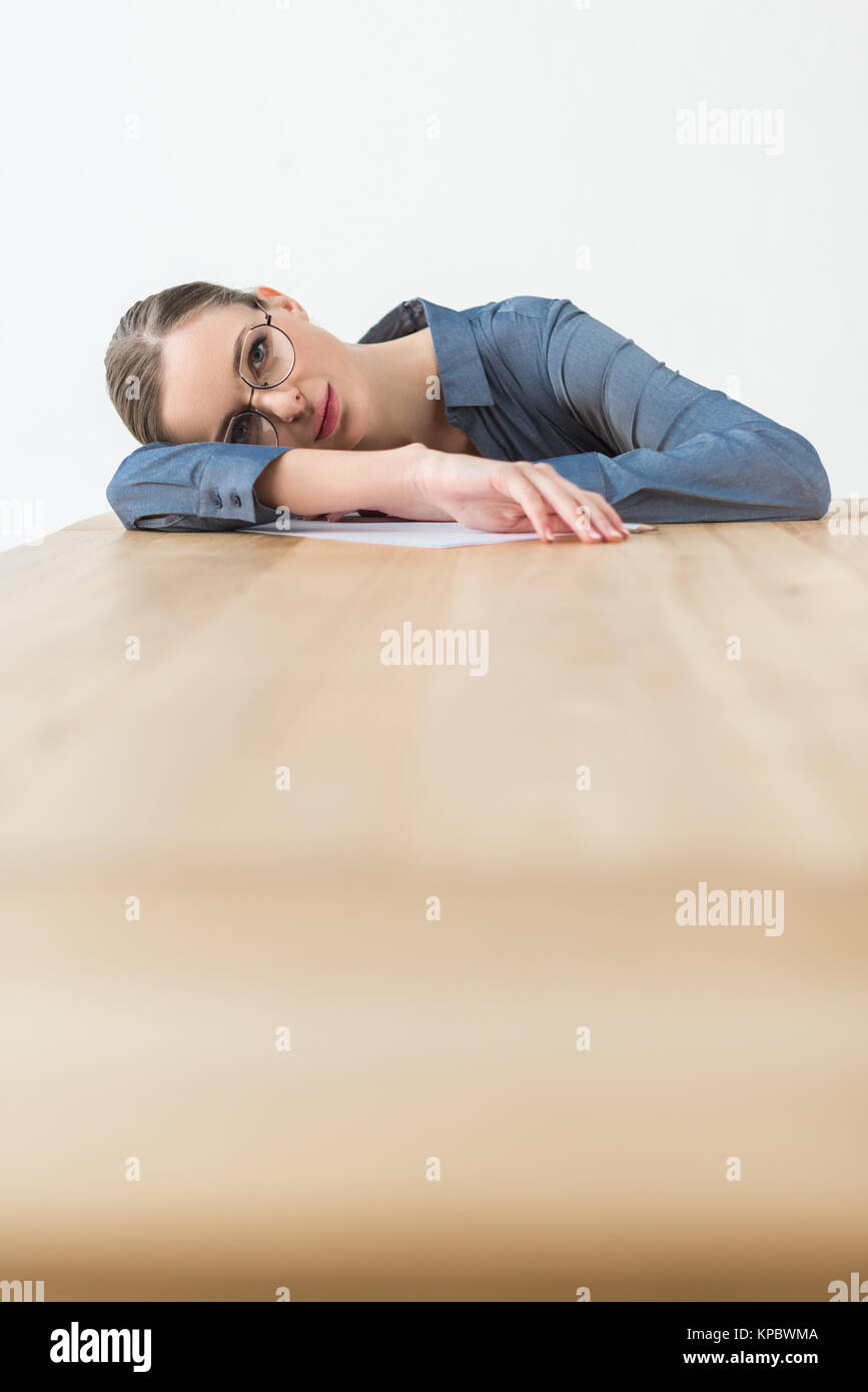 Tired businesswoman lying on table Stock Photo - Alamy