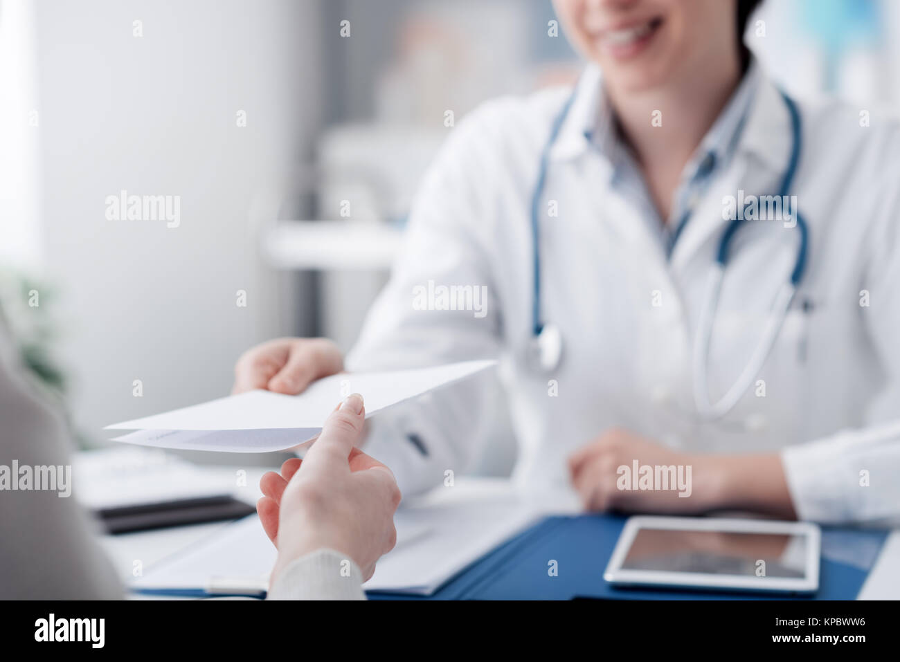 Female doctor meeting with a patient in the office, she is giving a ...