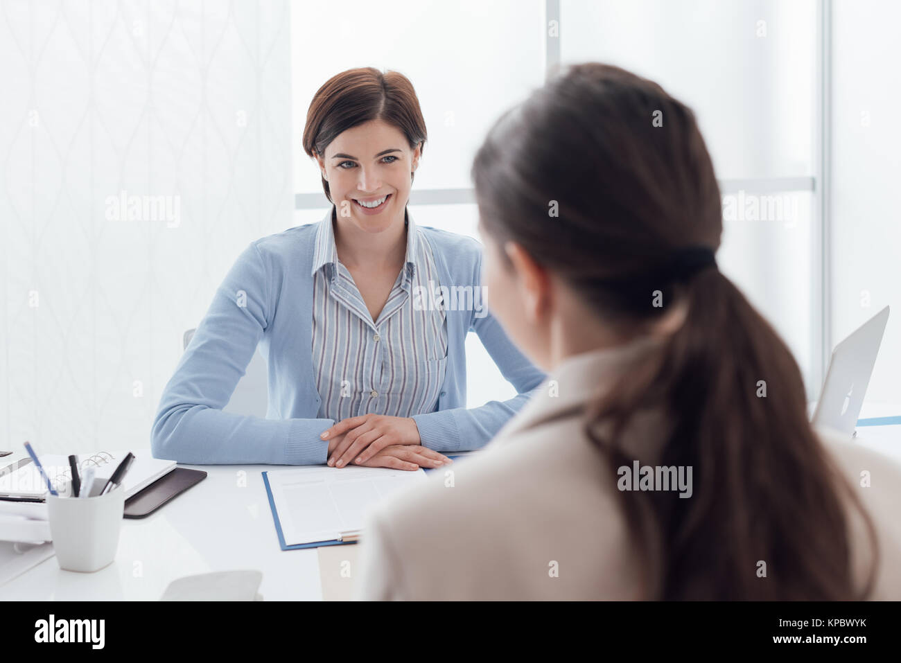 Business meeting in the office and job interview: a female executive is ...