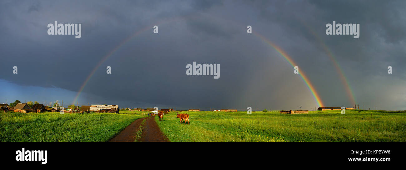 Rainbow over road Stock Photo - Alamy
