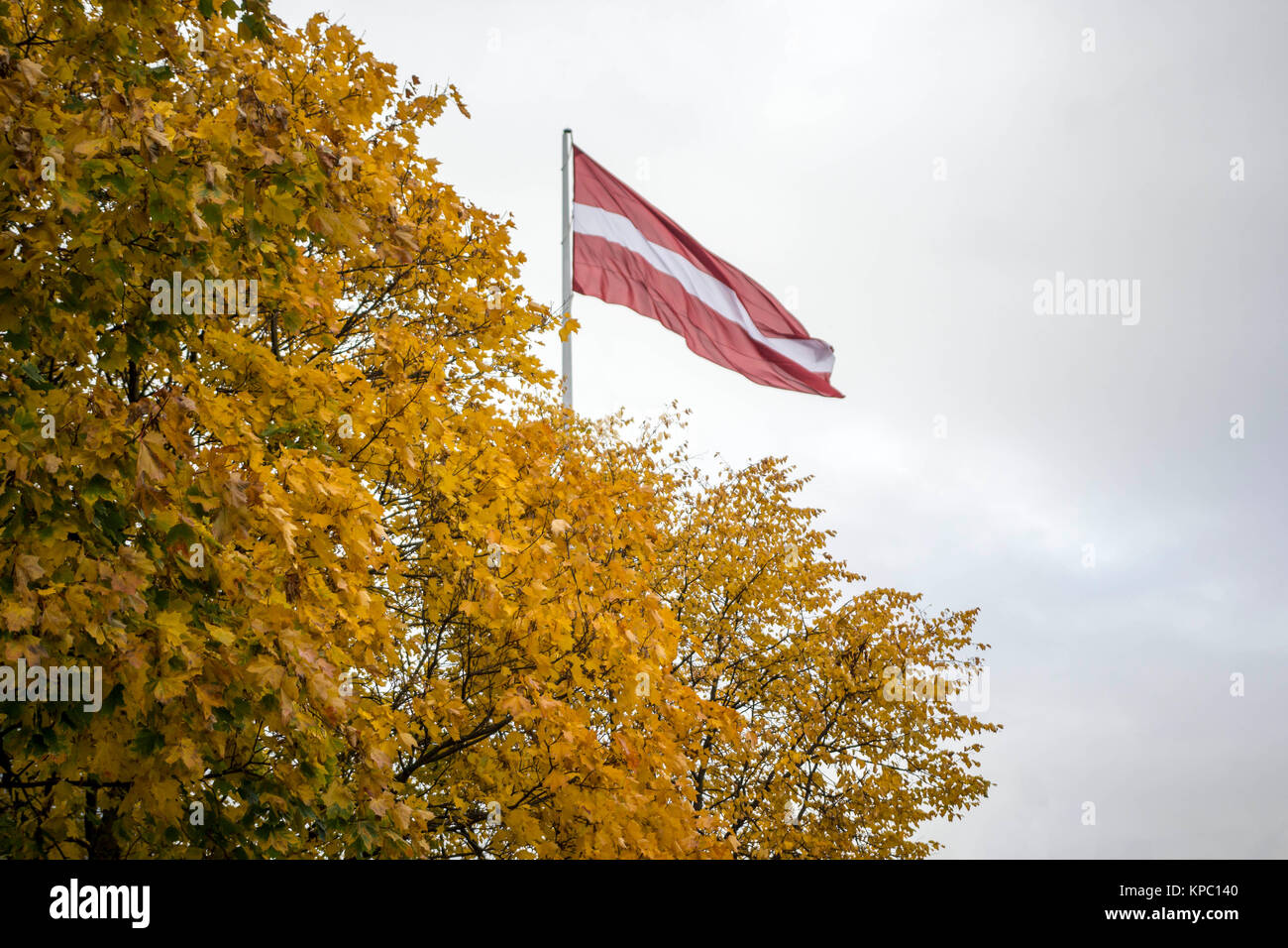 Latvian Flag in Autumn Blue Sky Stock Photo - Alamy
