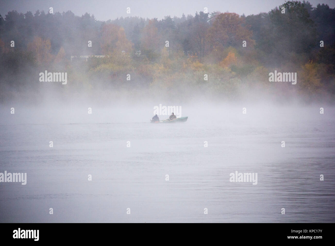 fishermans in boats fishing in big misty fog Stock Photo - Alamy