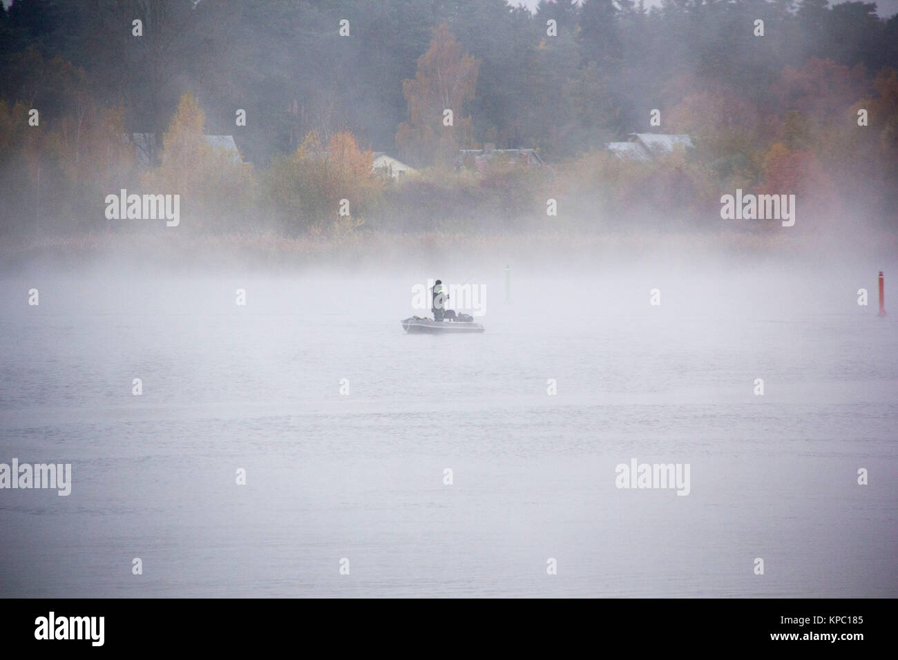 fishermans in boats fishing in big misty fog Stock Photo - Alamy